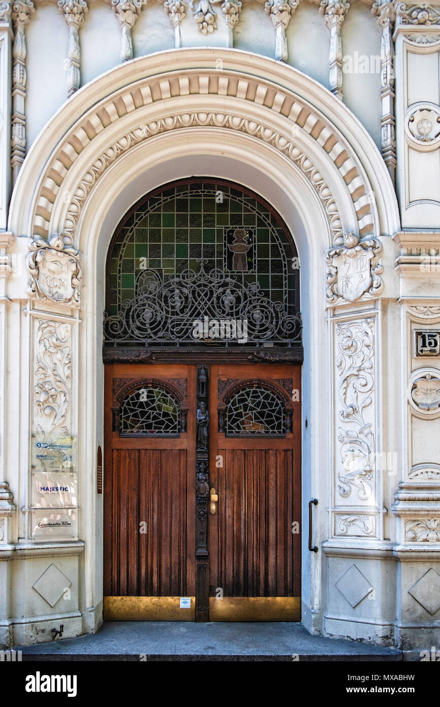 Grand Building Entrance, Ornate wooden door with decorative metal work ...