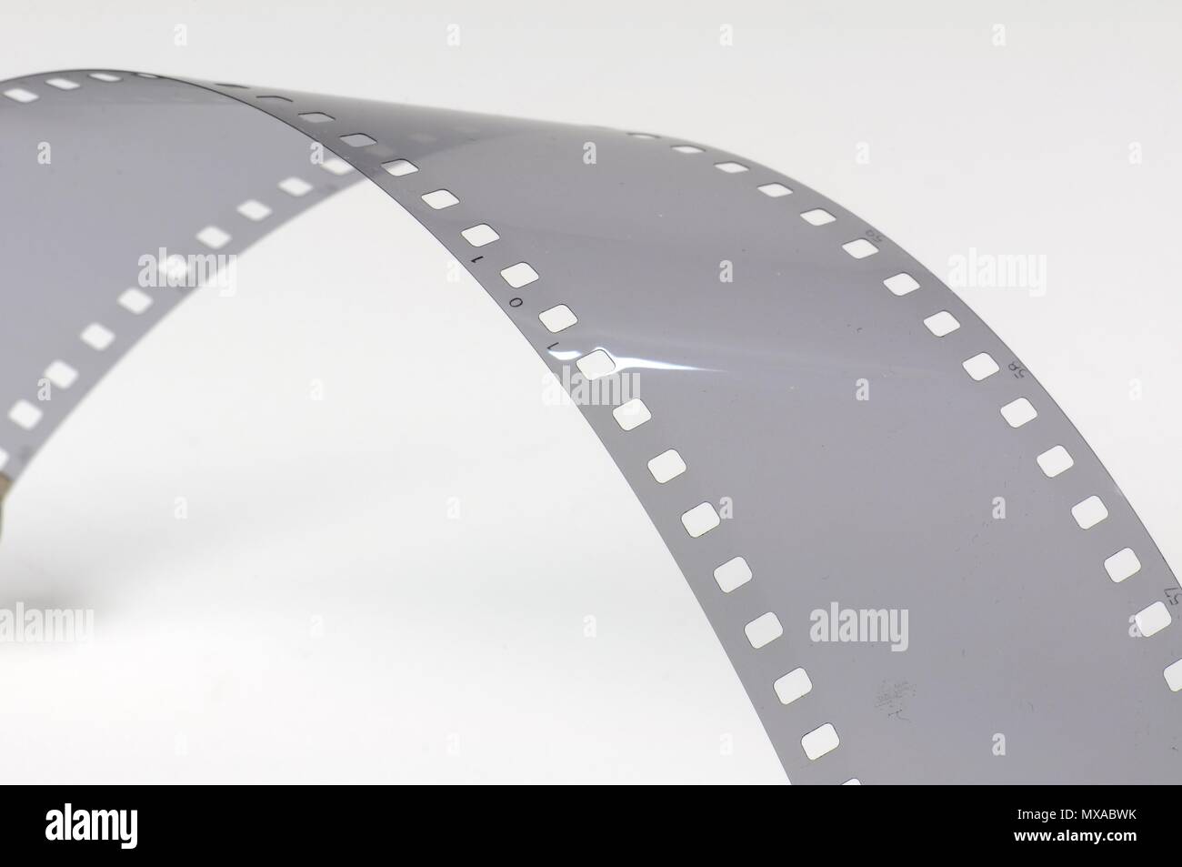 Twisted gray film strip on white background Stock Photo - Alamy