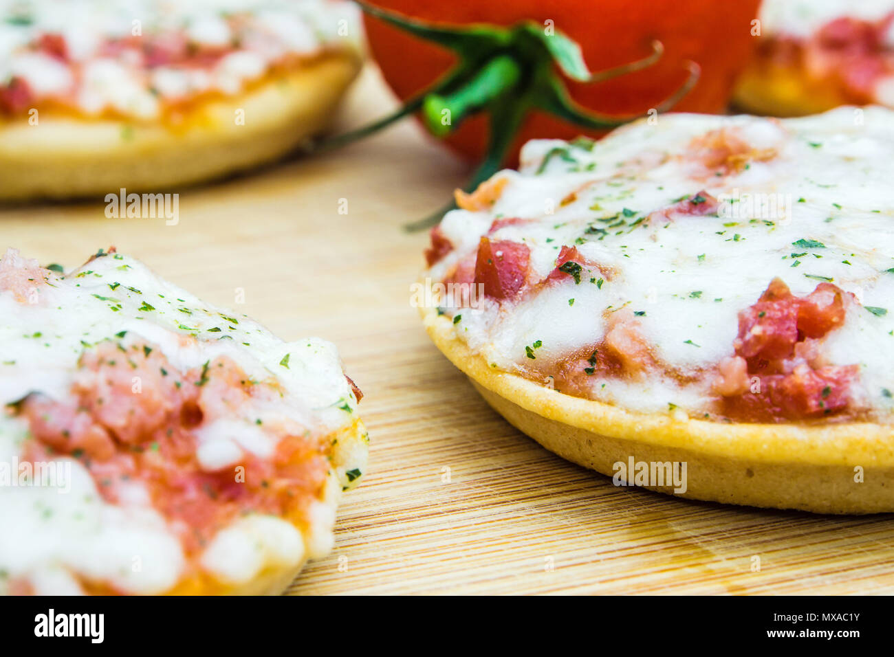 mini pizzas with ham and cheese on wooden plate Stock Photo - Alamy