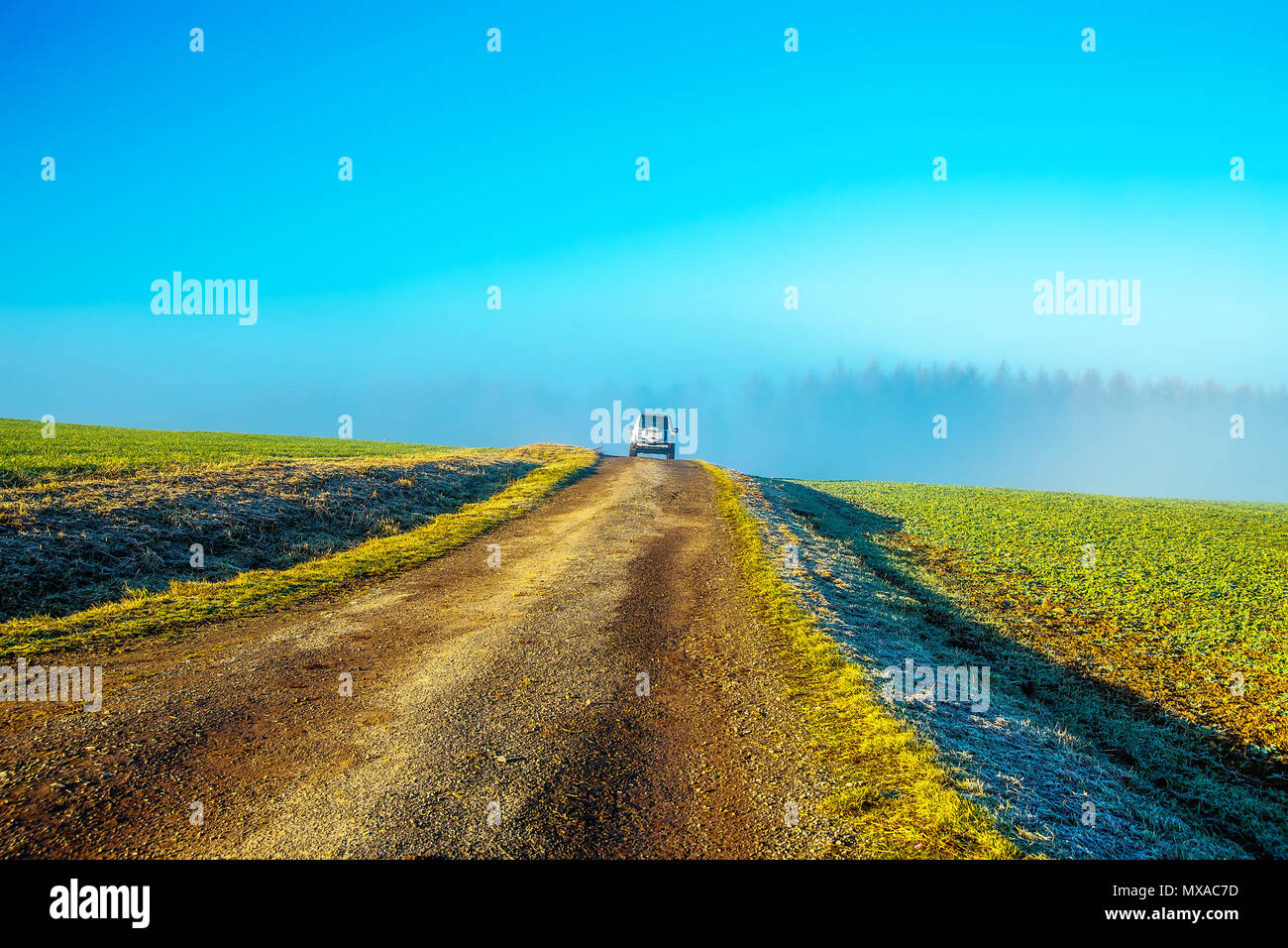 Beautiful field path with car in beautiful landscape Stock Photo - Alamy