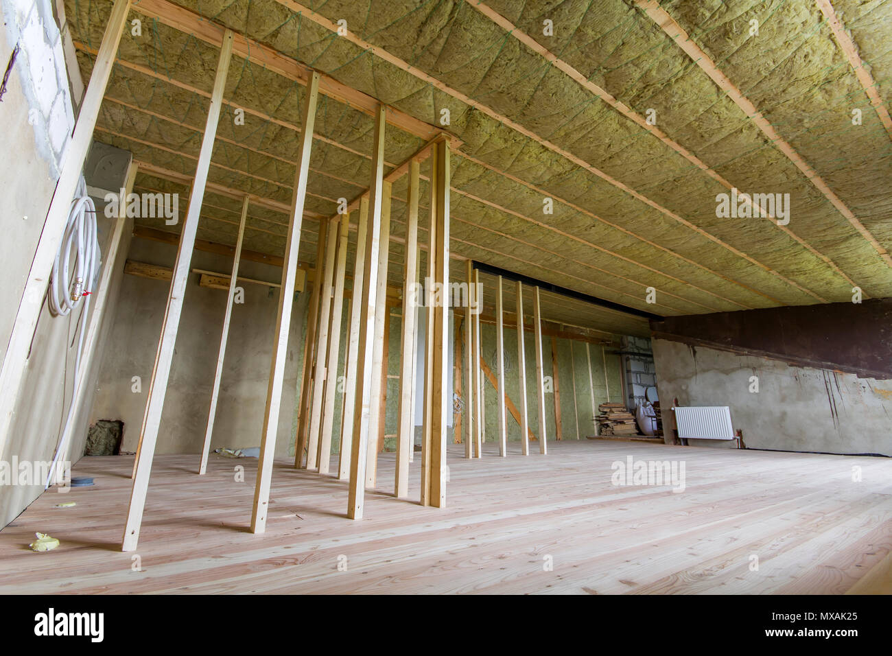 Construction and renovation of big spacious empty unfinished attic room ...