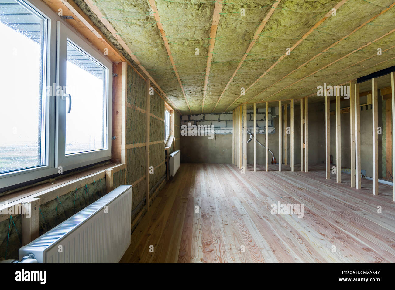 Construction and renovation of big light spacious empty room with oak ...