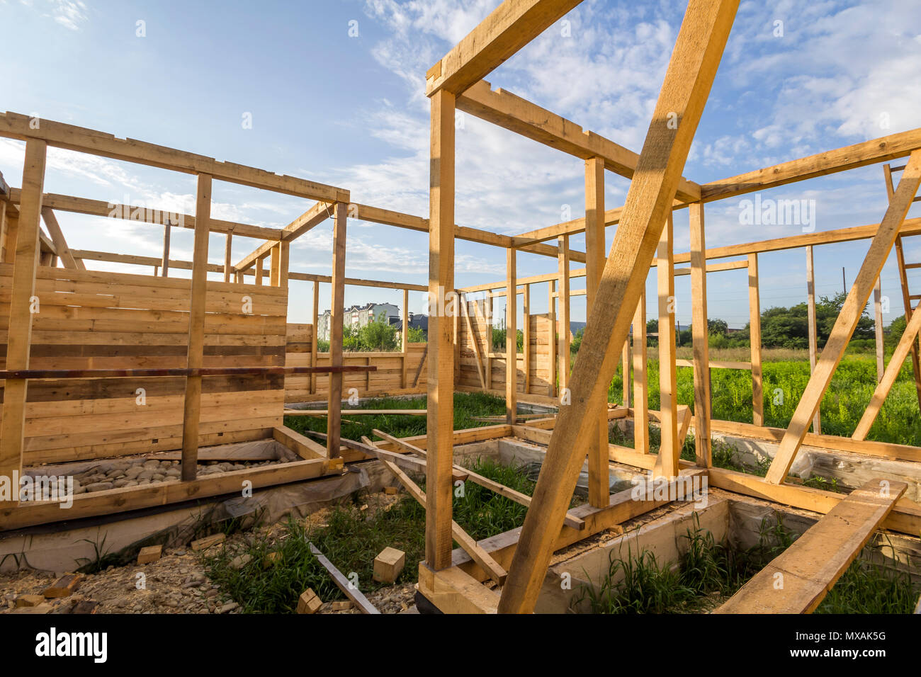 Building site of ecological house under construction in green field on ...