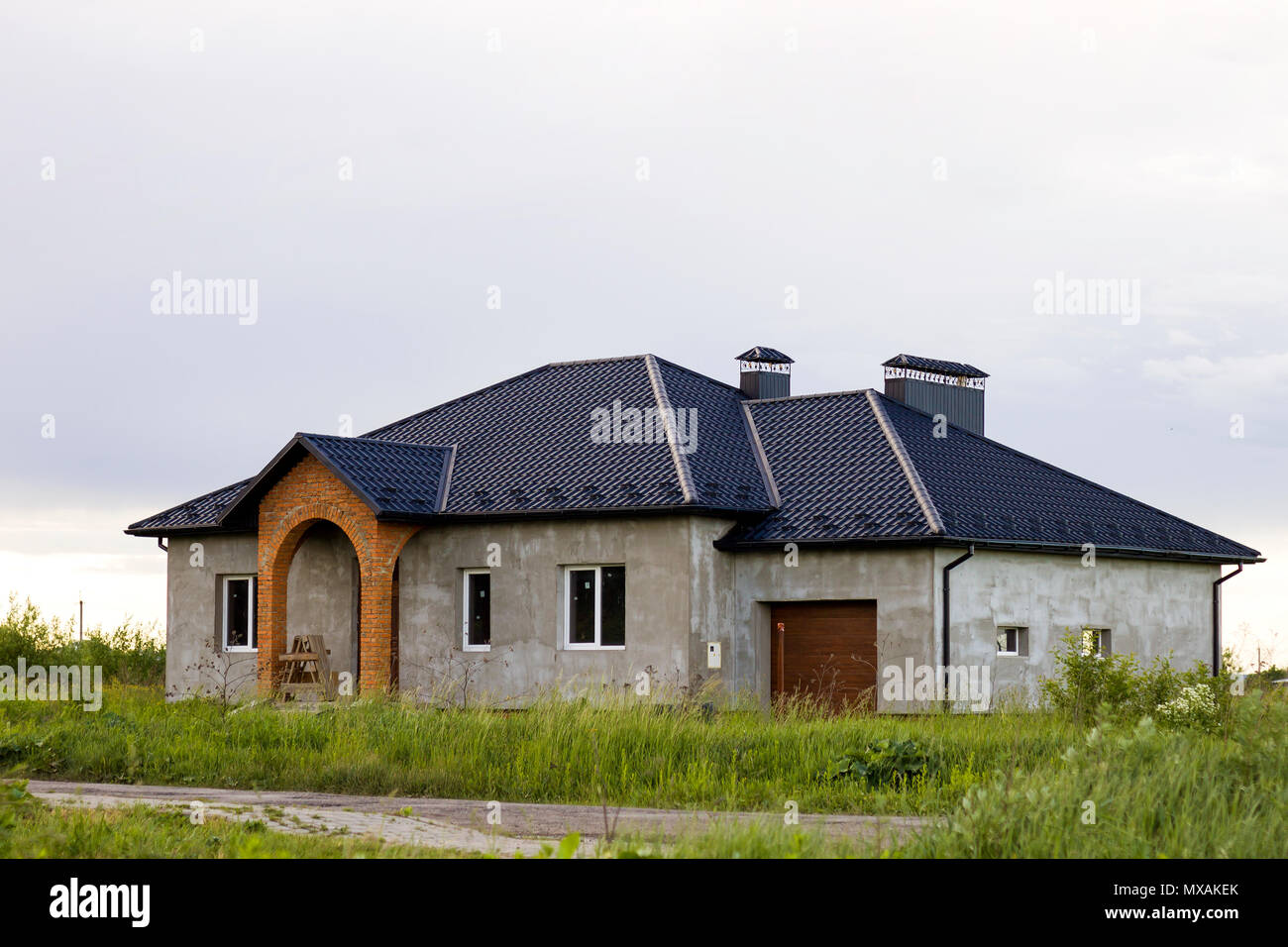 New built not lived yet one-store gray house with tiling roof, plastic ...