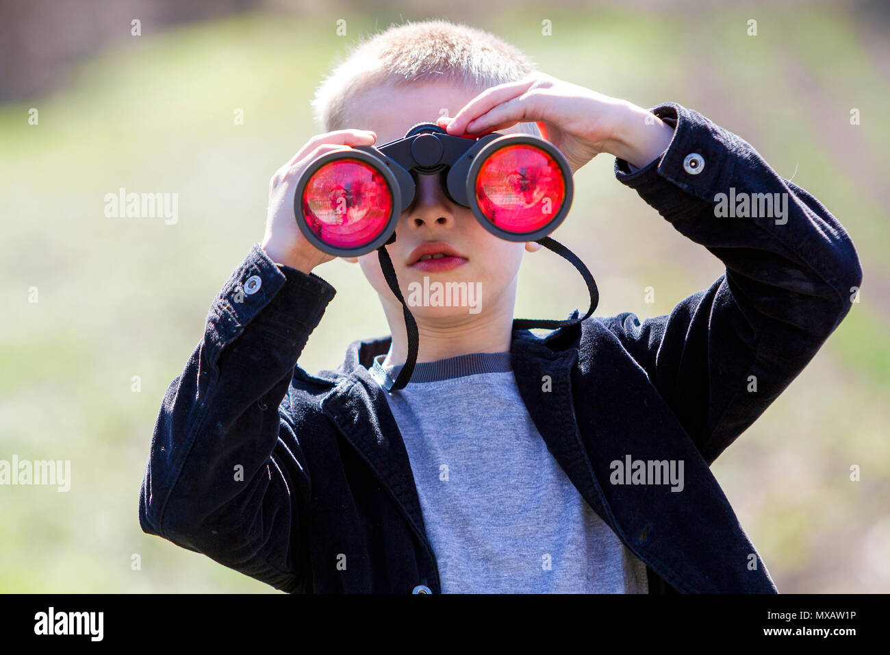 Portrait of little cute handsome cute blond boy watching intently ...