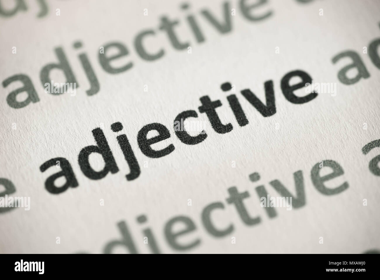 word adjective printed on white paper macro Stock Photo - Alamy