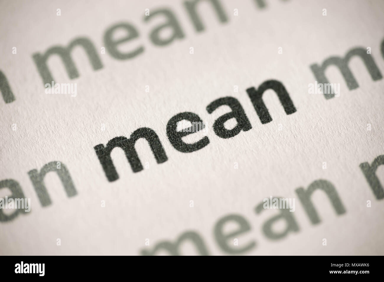 word mean printed on white paper macro Stock Photo - Alamy