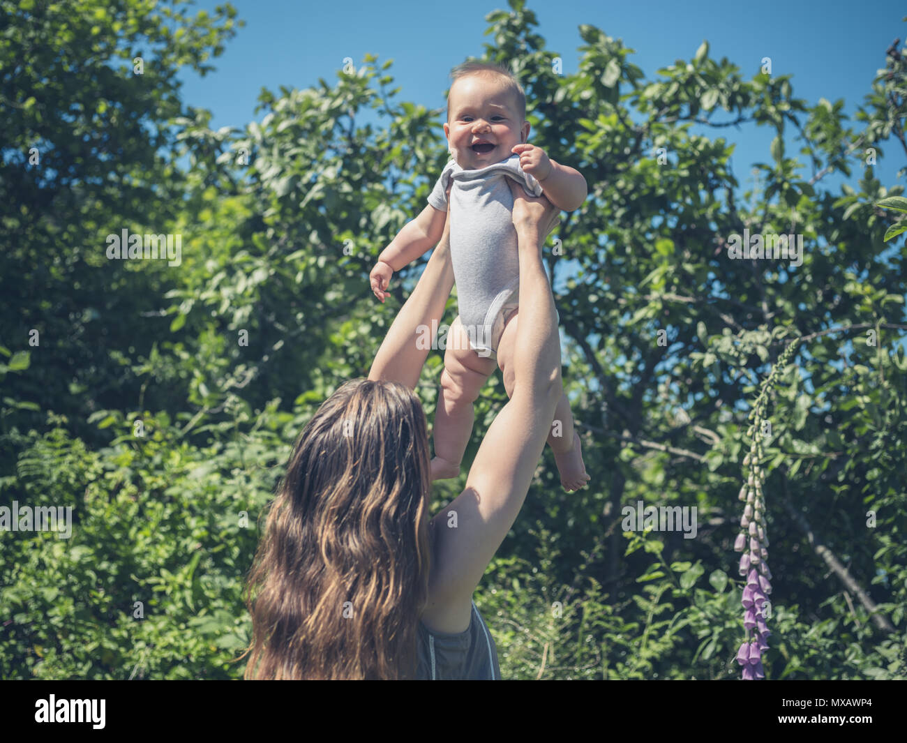 Mother lifting up her child hi-res stock photography and images - Alamy