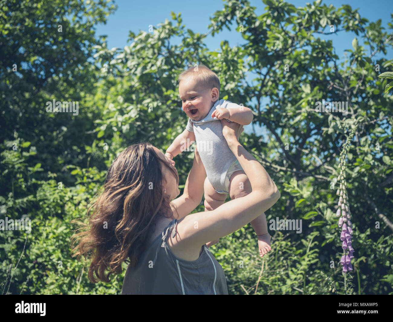 Mother lifting up her child hi-res stock photography and images - Alamy
