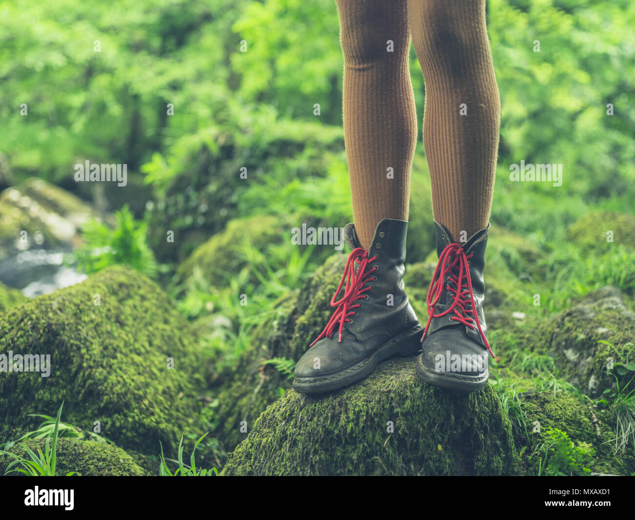 The legs of a young woman wearing hiking boots in nature Stock Photo ...