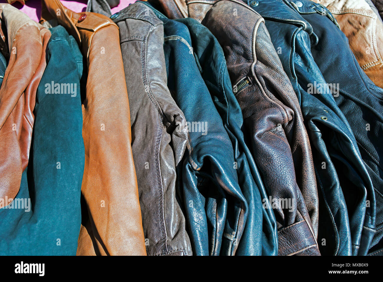 Different color leather jackets next to each other Stock Photo - Alamy