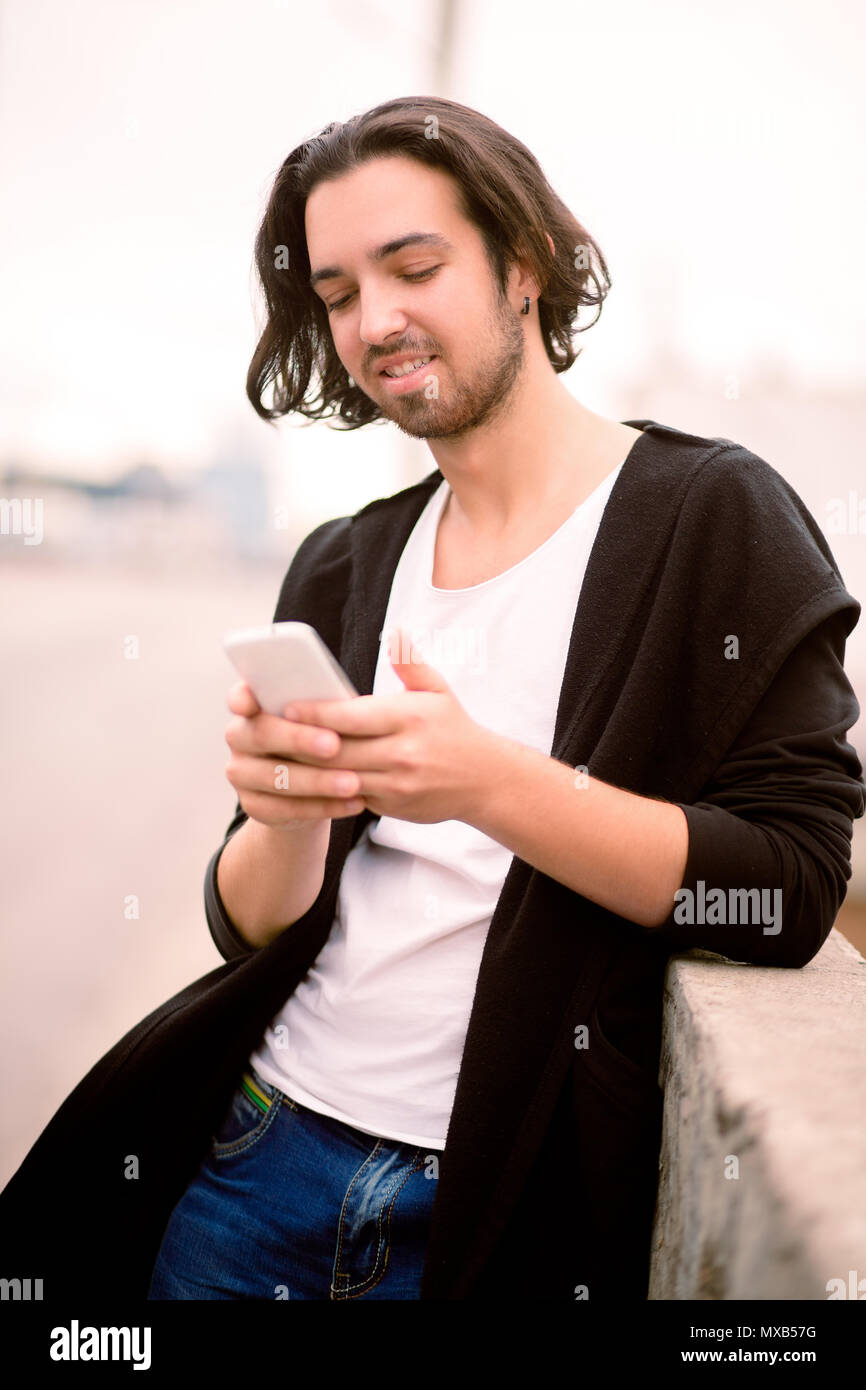 Portrait of a confident young man walking outside Stock Photo - Alamy