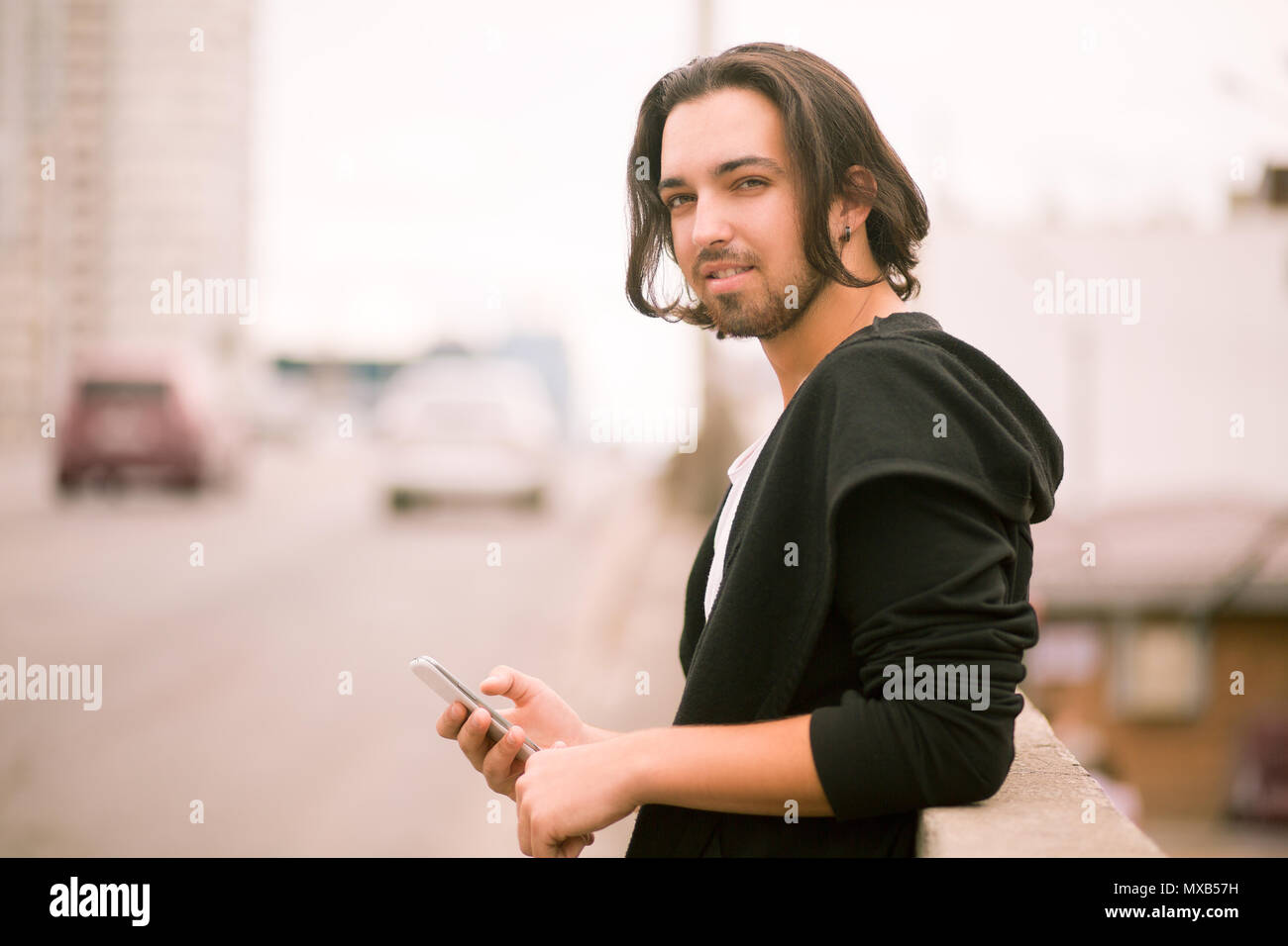Portrait of a confident young man walking outside Stock Photo - Alamy