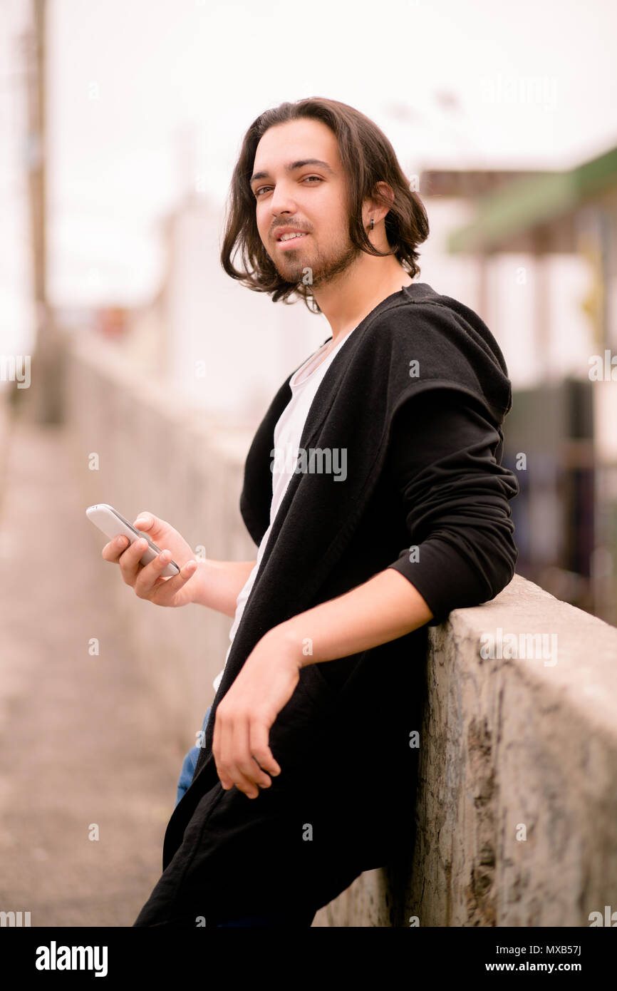 Portrait of a confident young man walking outside Stock Photo - Alamy