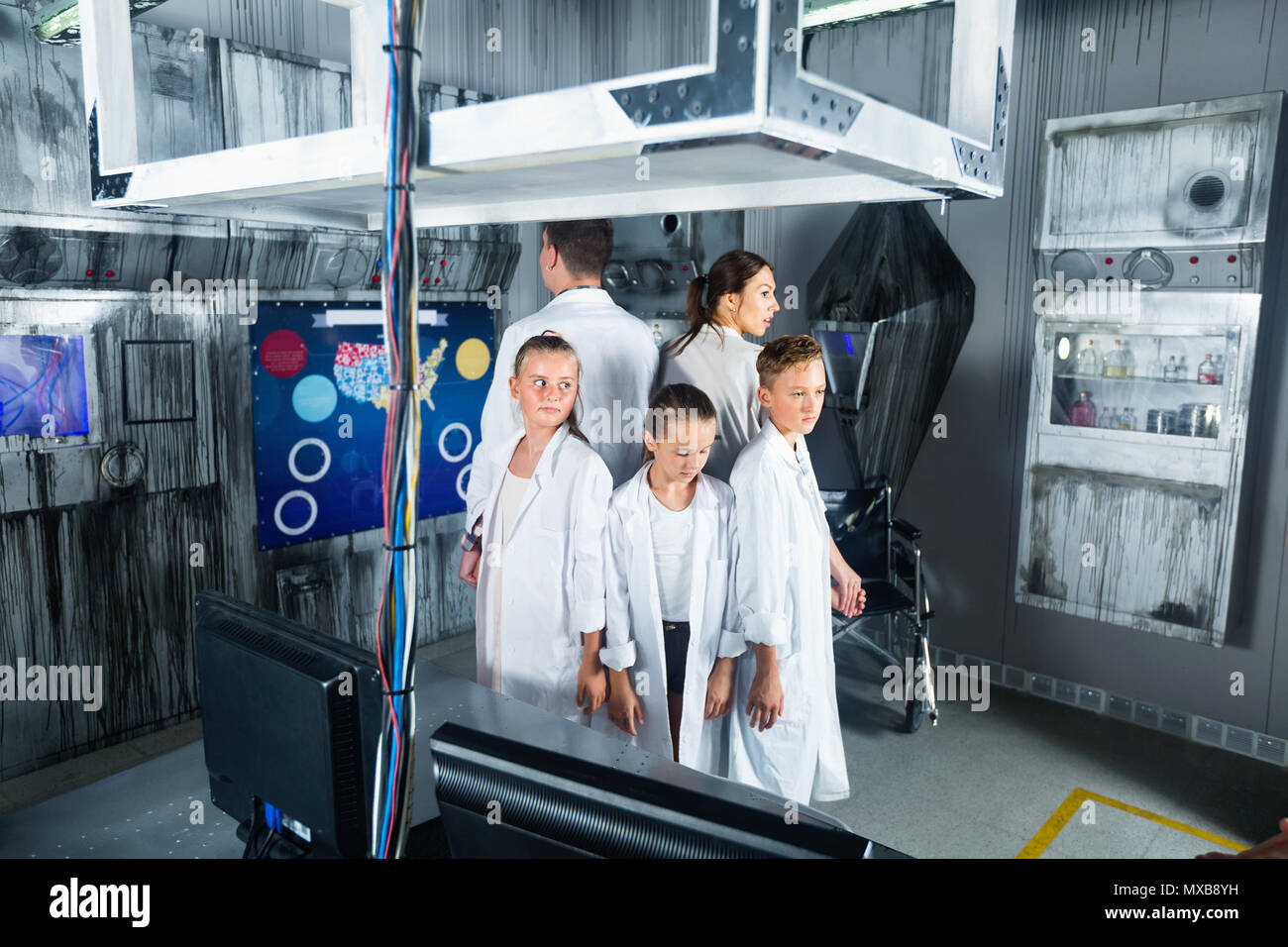 Happy positive family of five is having fun together in lost labroom ...