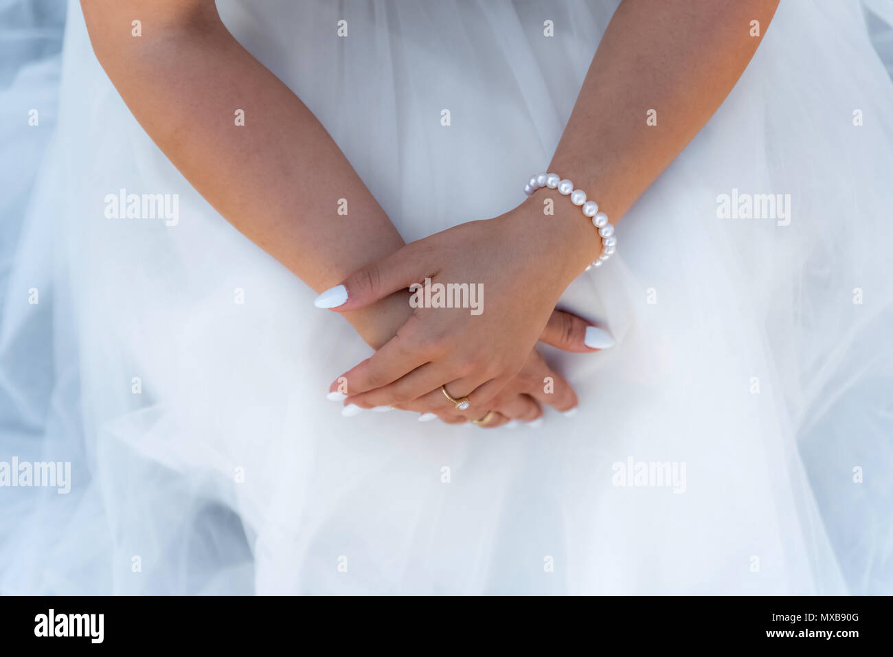 Bride hands on wedding dress Stock Photo - Alamy