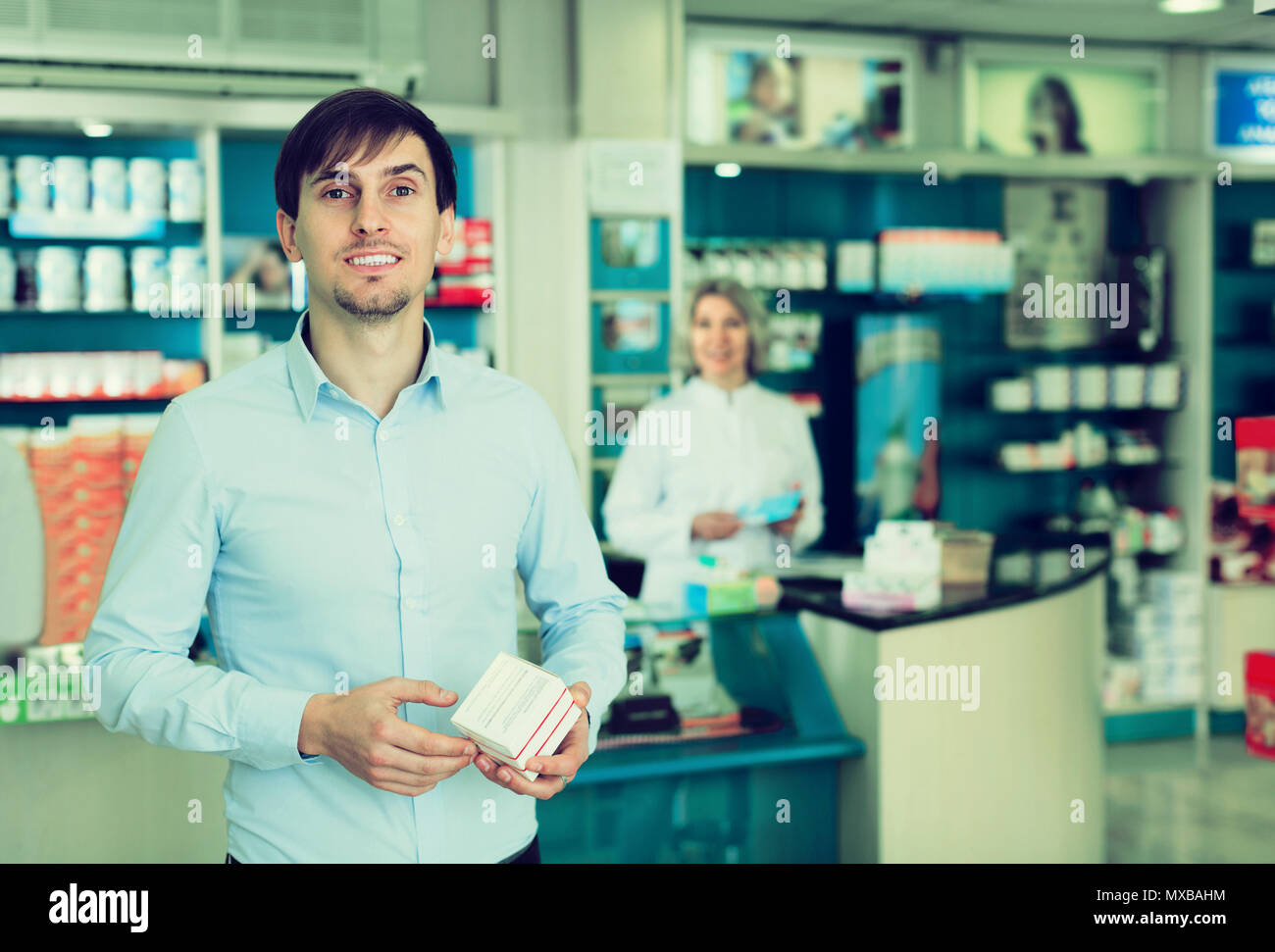 Young man near counter in pharmacy drugstore Stock Photo - Alamy