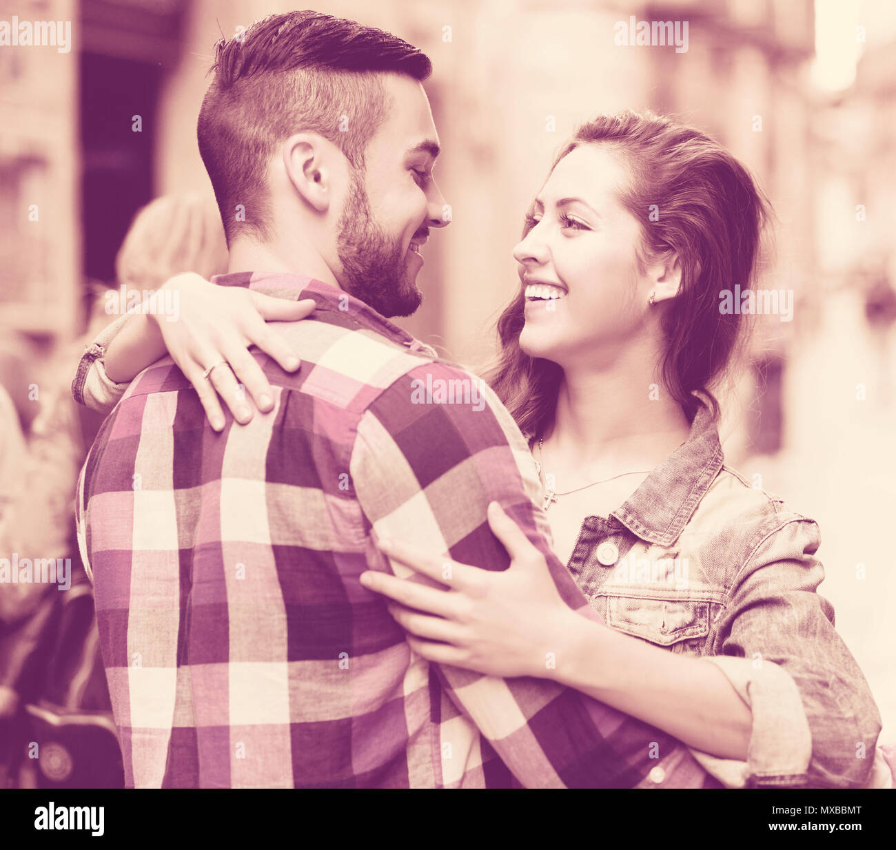 Happy girl hugging her male friend outdoors Stock Photo - Alamy