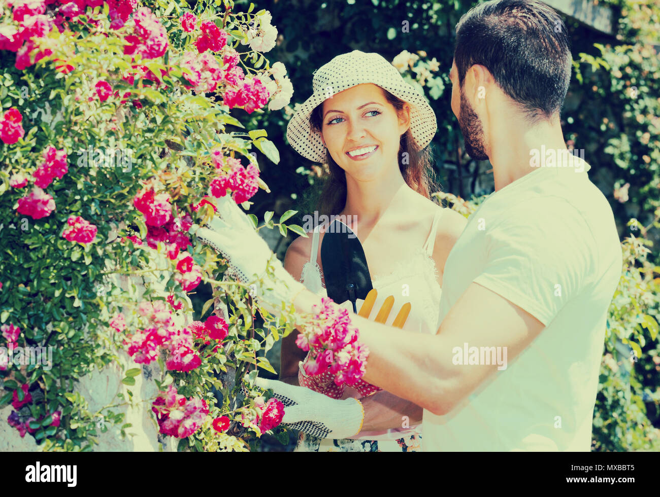 Happy family in garden flowers with horticultural sundry for planting ...