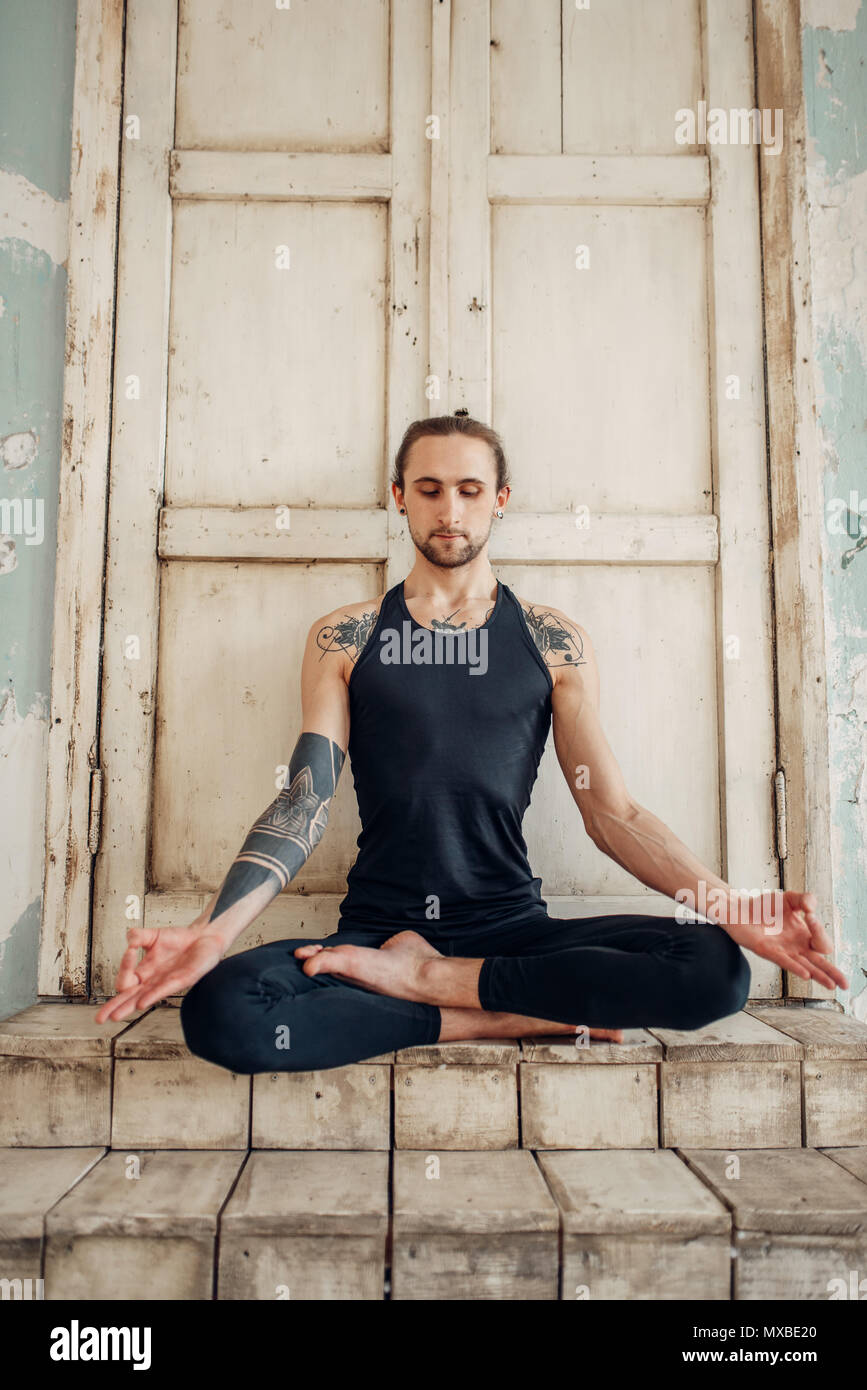 Male yoga, meditation in asana position, full relaxation. Fit workout ...