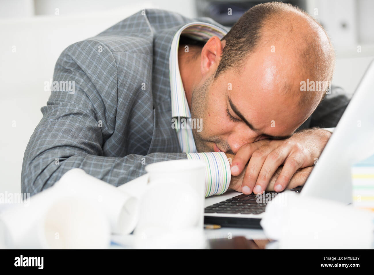Young sad man tired of working and sleeping in the modern office Stock ...