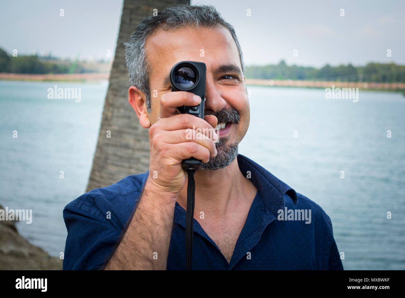 Man with old vintage camera in hands Stock Photo - Alamy