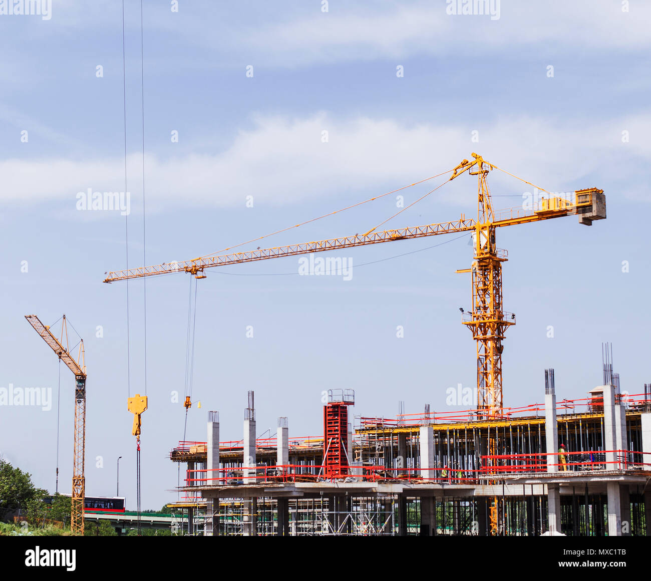 Construction crane on construction site over cloudy sky, Support and ...
