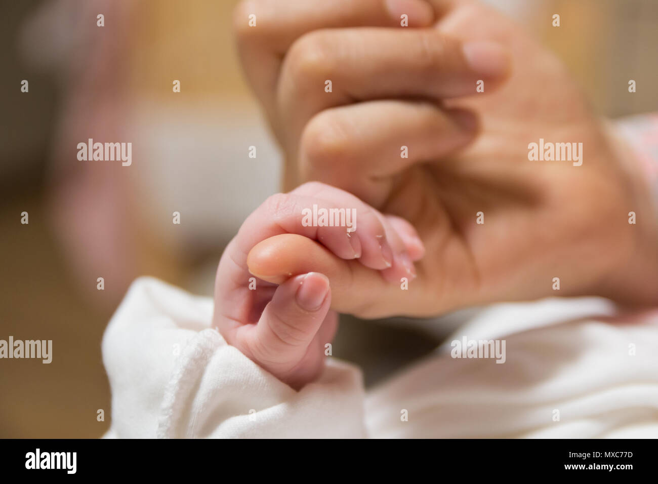 New born baby grip his mother's finger. The love of a mother concept ...