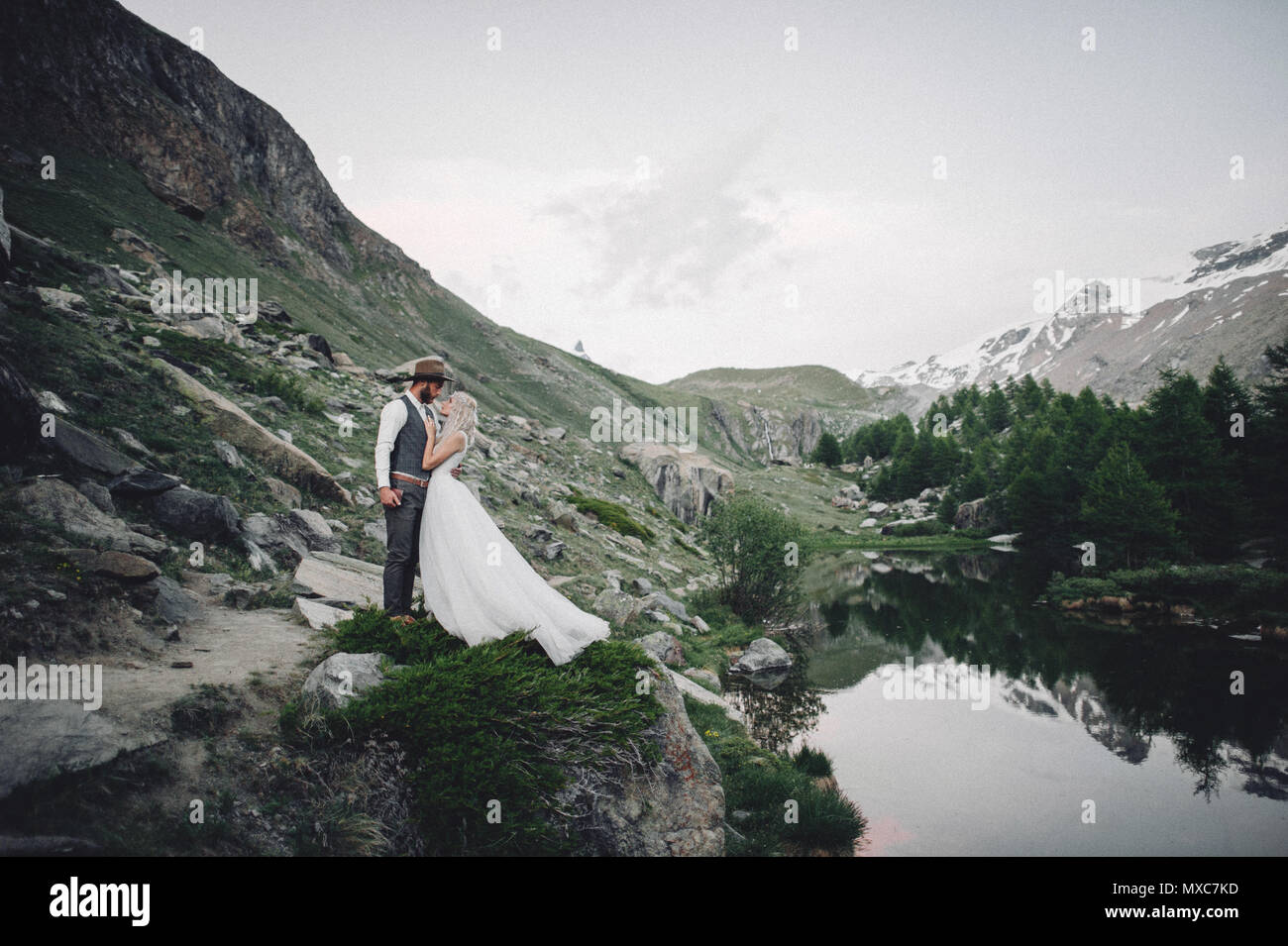Stylish young wedding couple posing in beautiful Matterhorn moun Stock ...