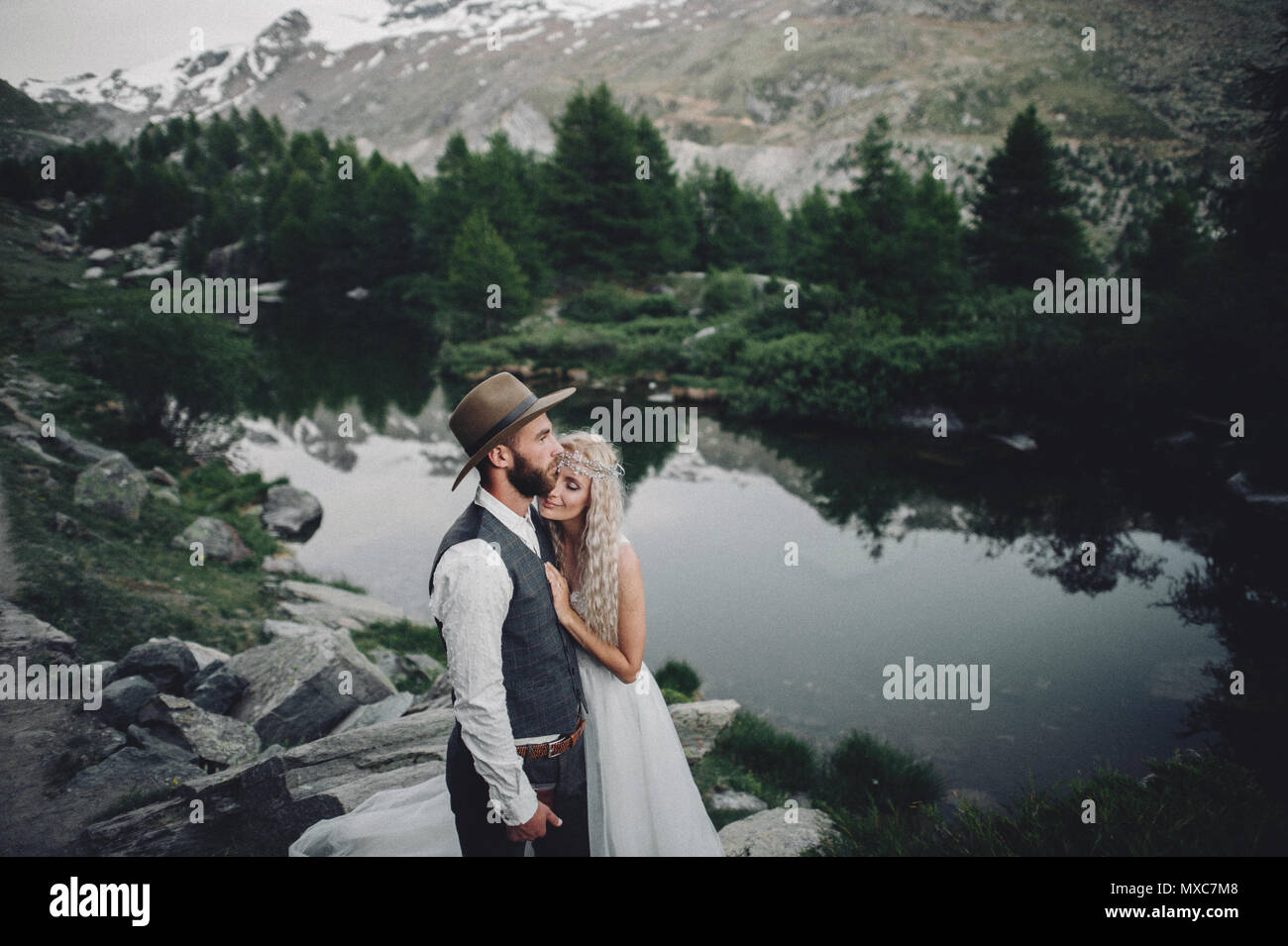 Stylish young wedding couple posing in beautiful Matterhorn moun Stock ...