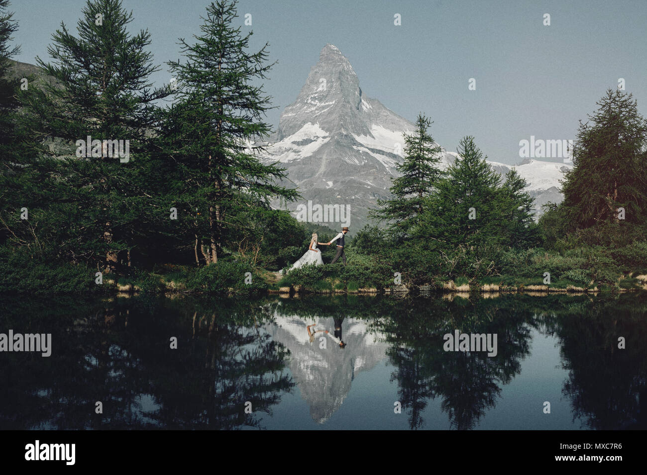 Stylish young wedding couple posing in beautiful Matterhorn moun Stock ...