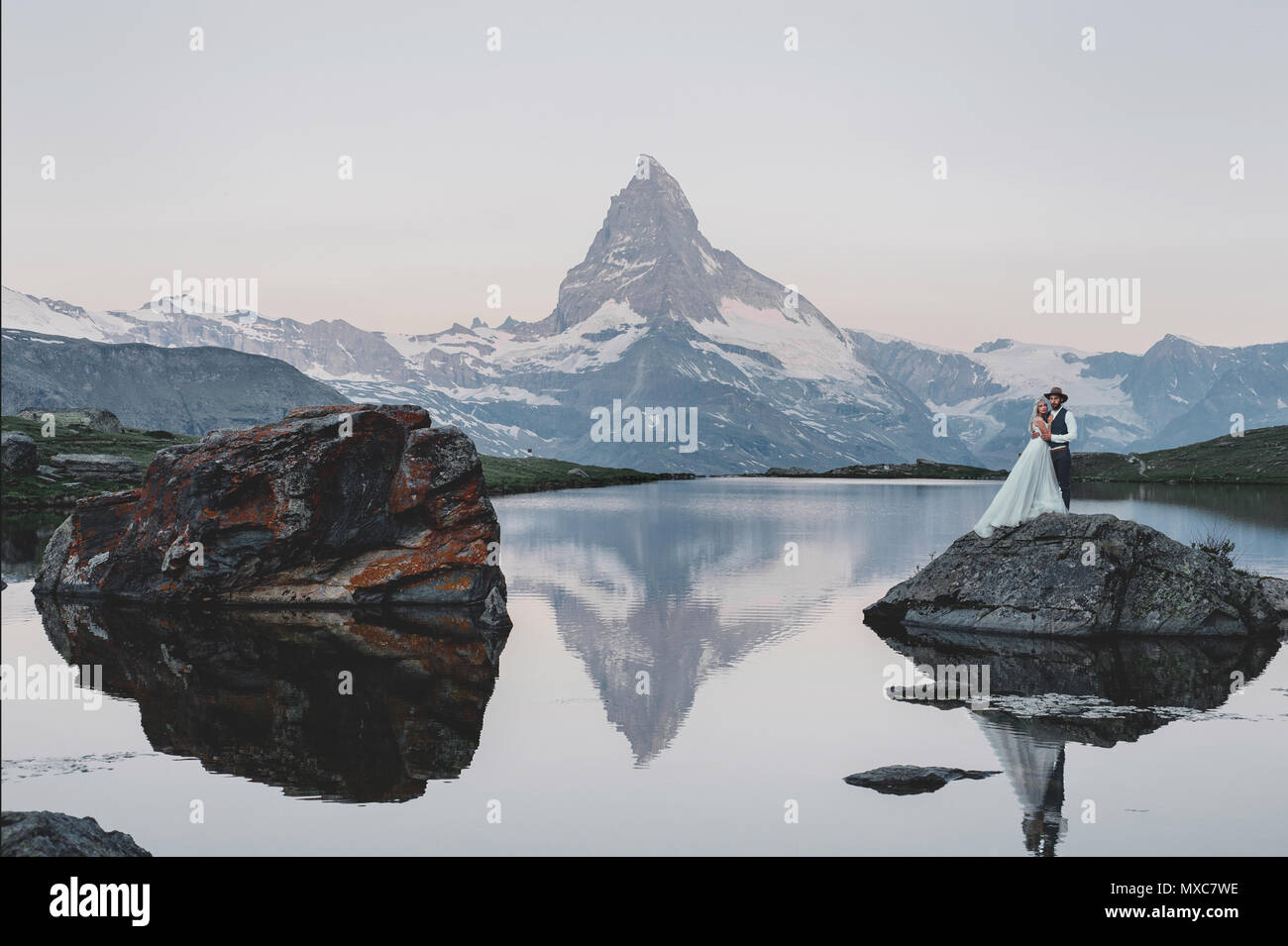 Stylish young wedding couple posing in beautiful Matterhorn moun Stock ...