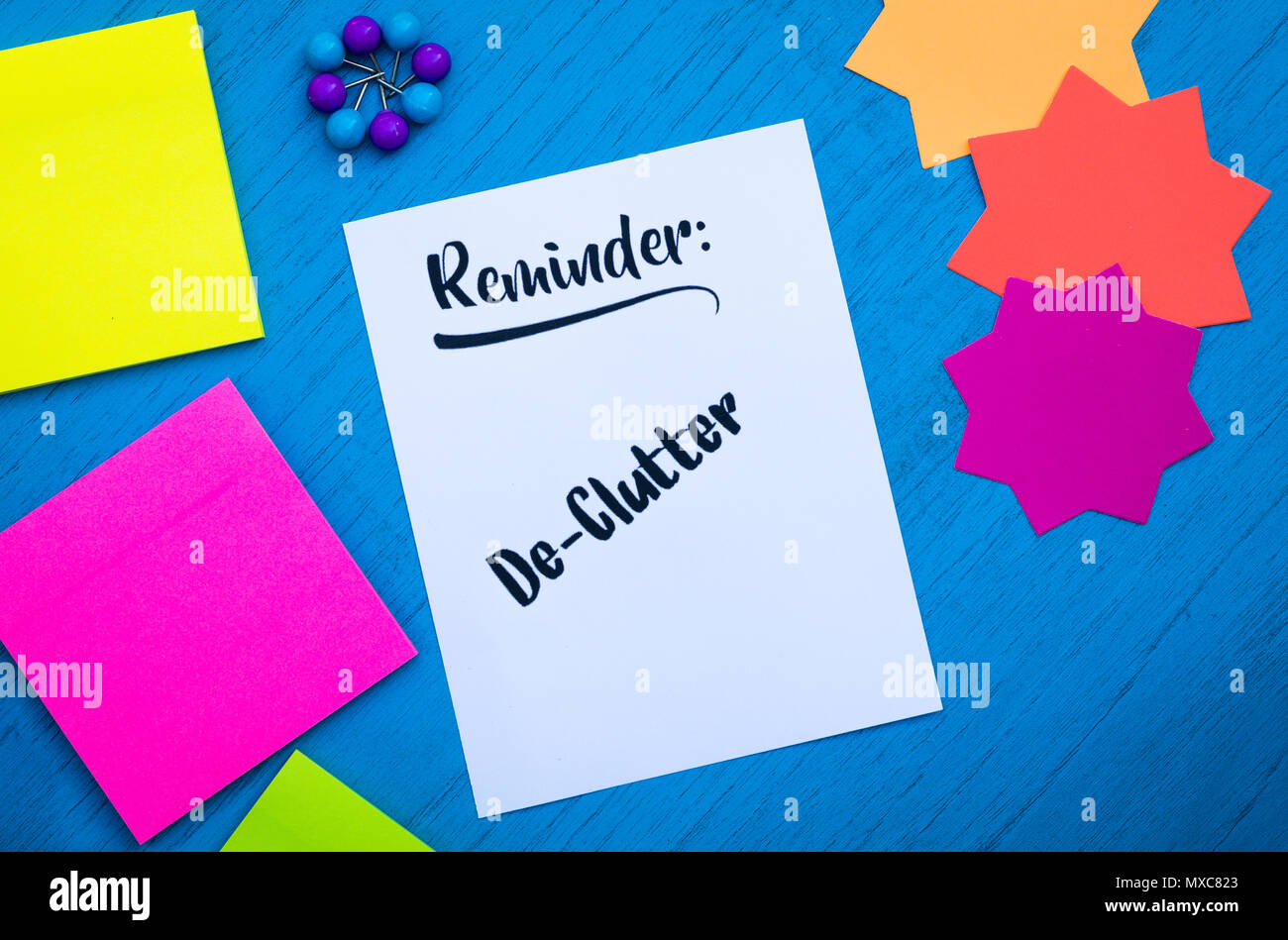 Reminder to De-Clutter still life motivational concept on white paper ...