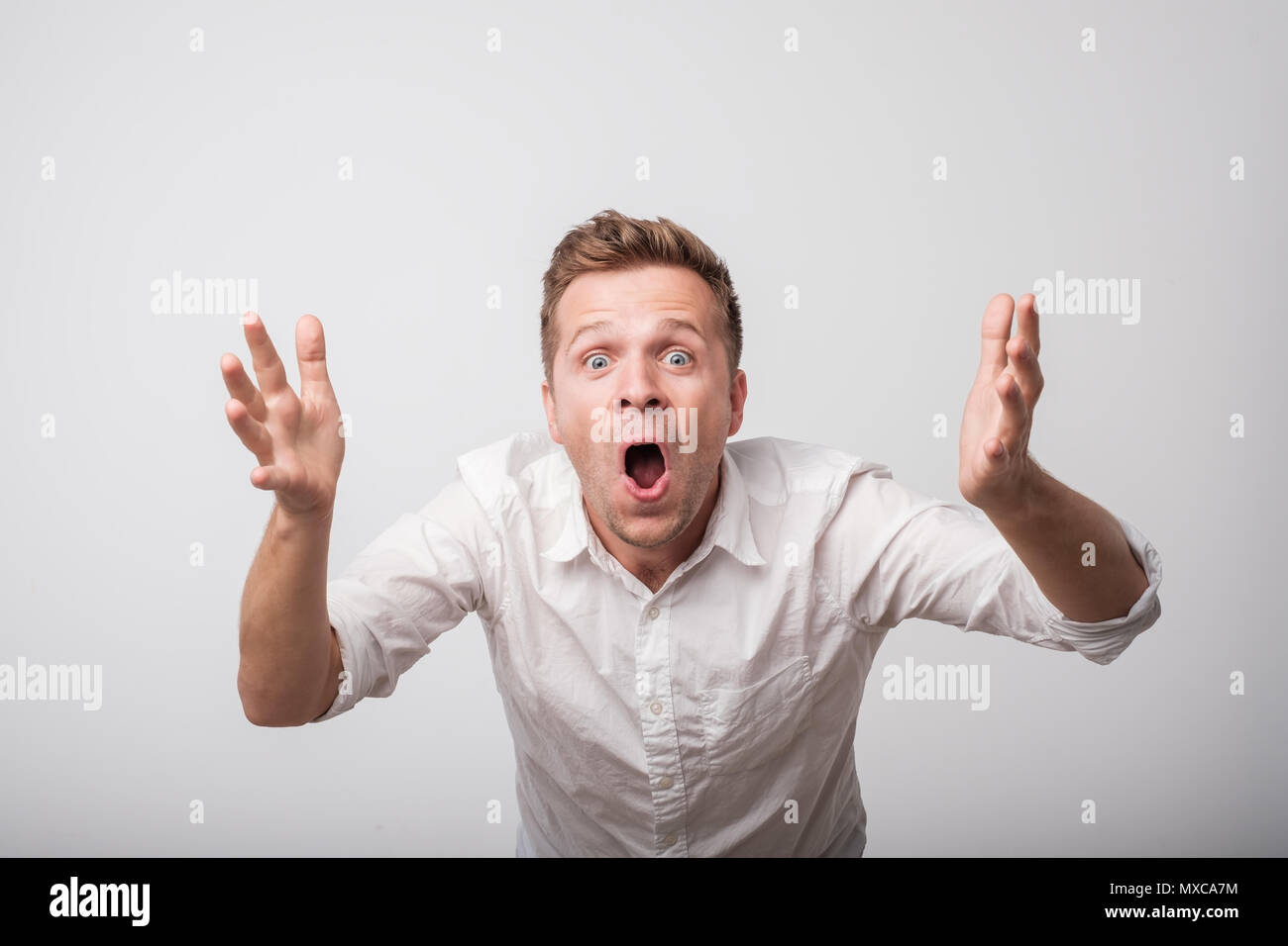 Shocked caucasian man screaming Stock Photo - Alamy