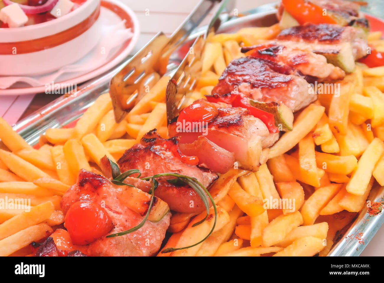 Tasty grilled meat on fries Stock Photo - Alamy