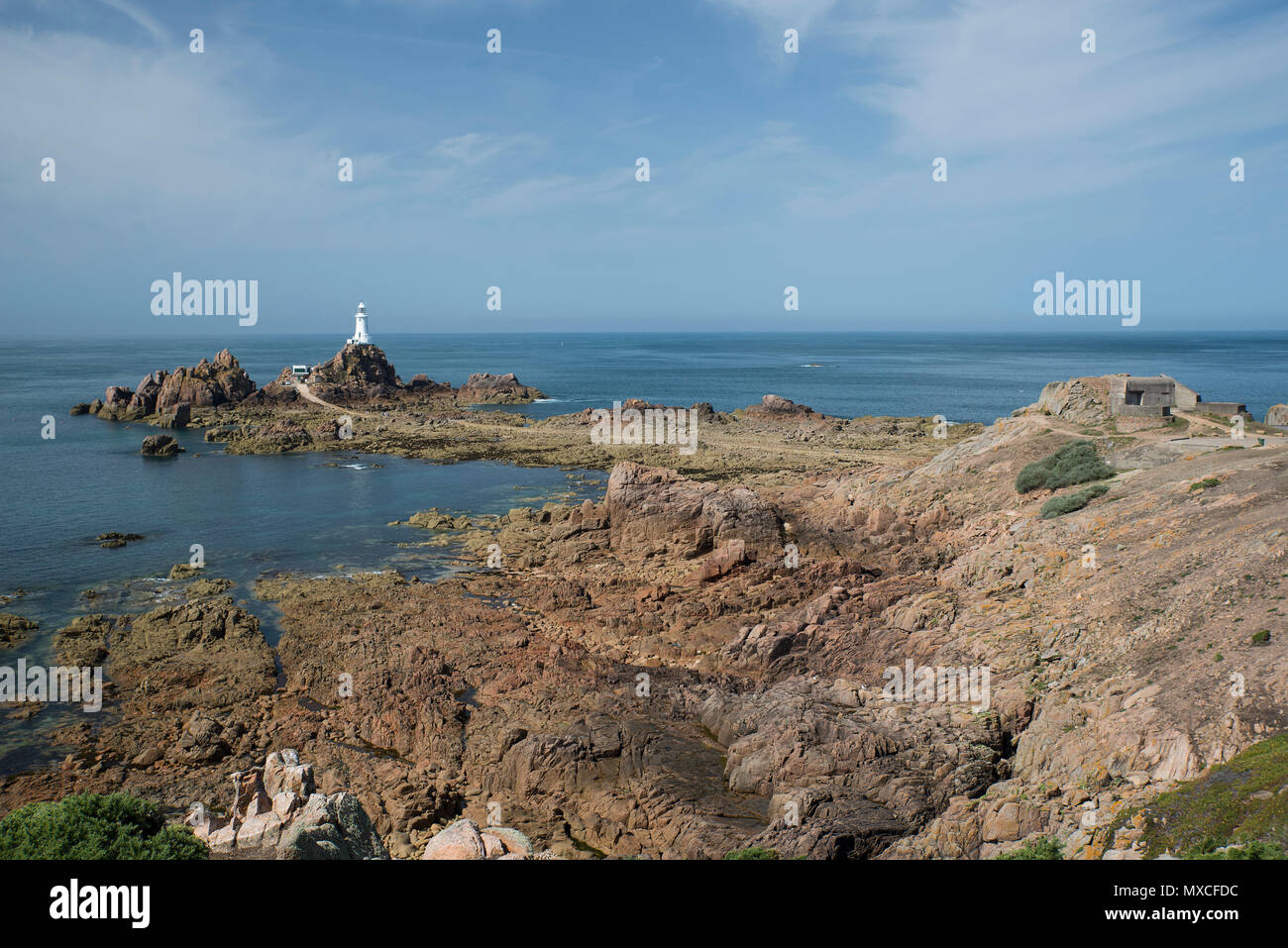 lighthouse and a German WW2 pillbox on the coast of Jersey Stock Photo ...