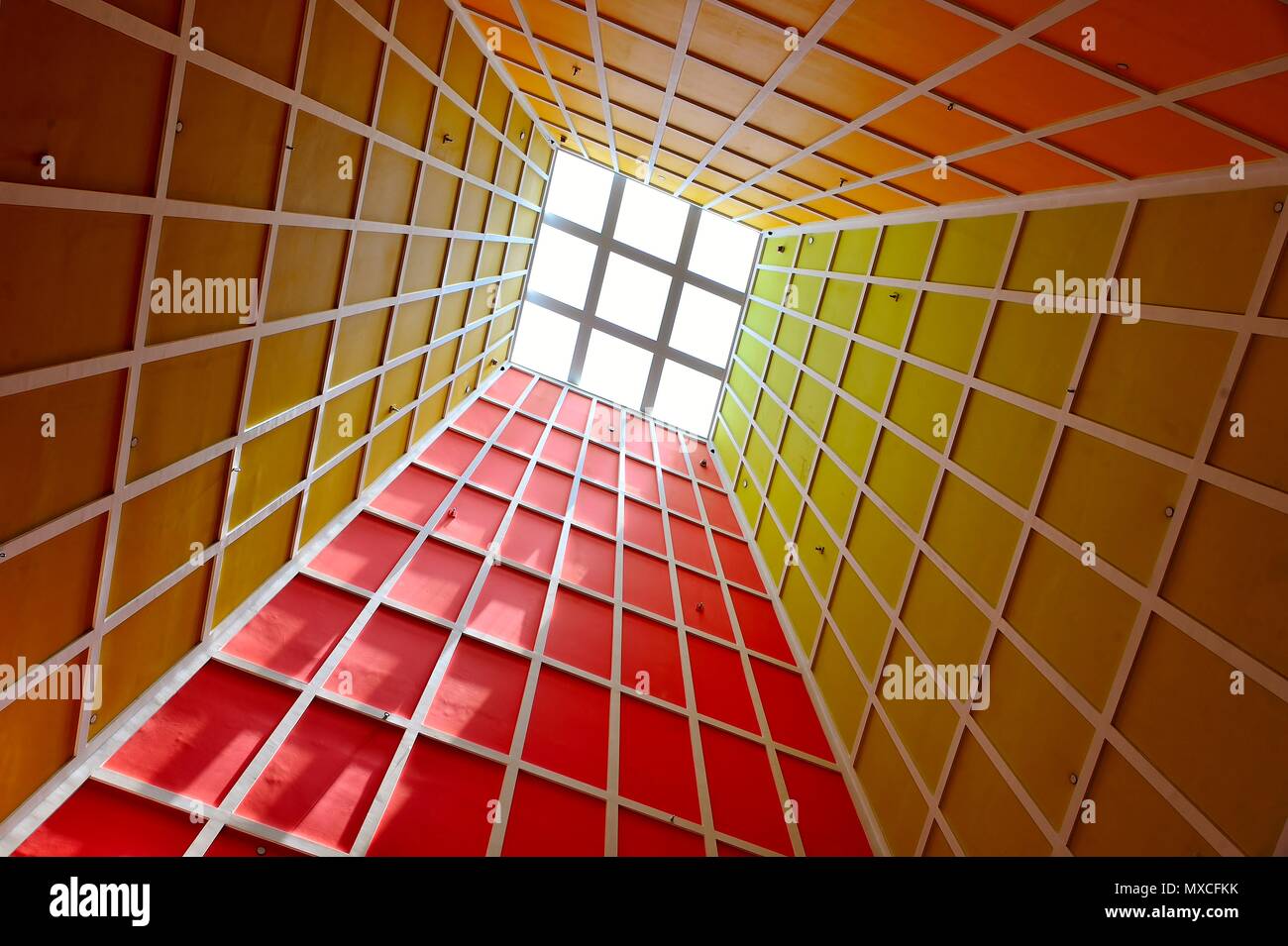 Abstract perspective of vertical lobby ceiling with skylight and strong ...