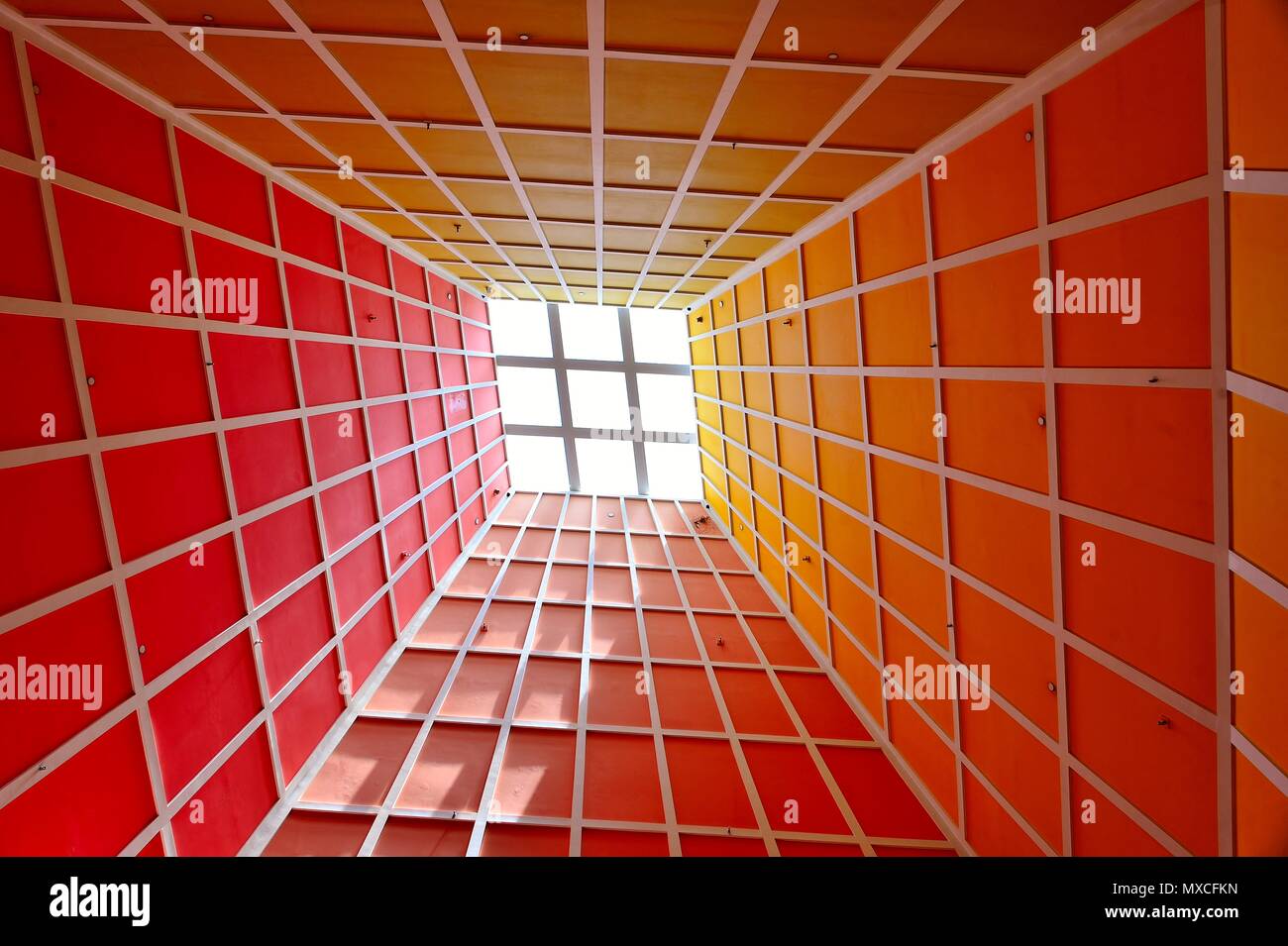 Abstract perspective of vertical lobby ceiling with skylight and strong ...