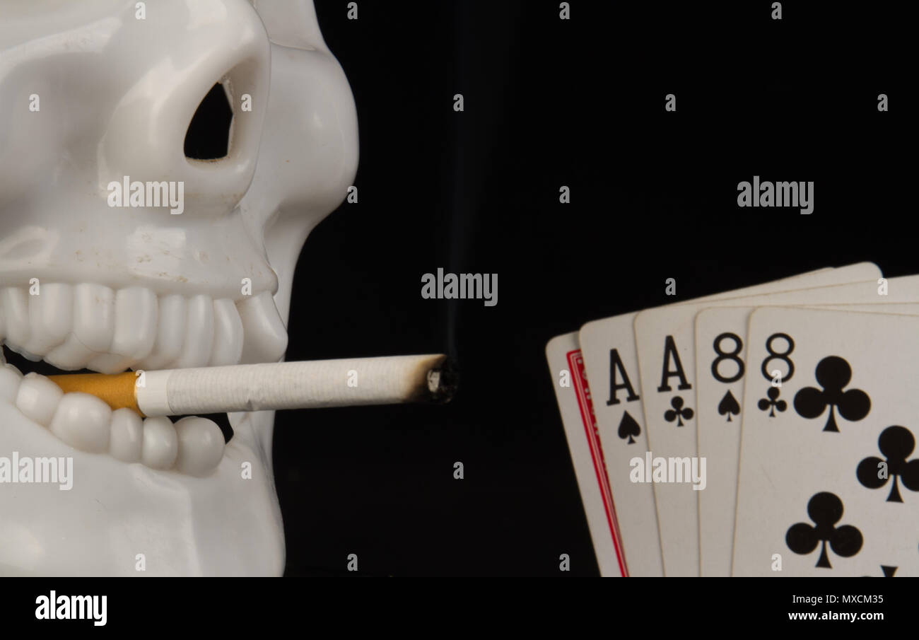 Skull with a cigarette in its mouth - the dangers of smoking - against ...
