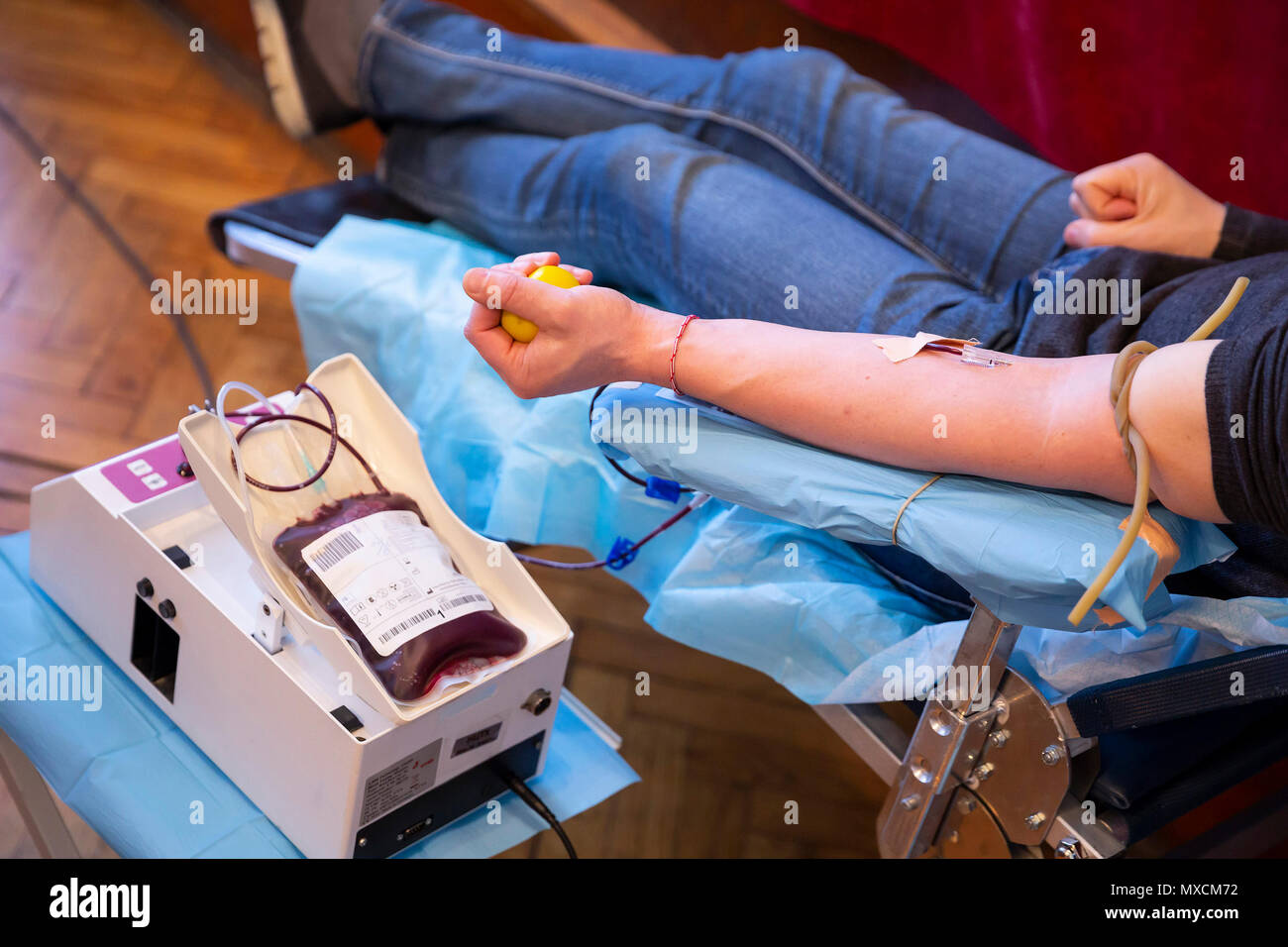 The hand of a man who donates blood. Male donor gives blood in a mobile ...
