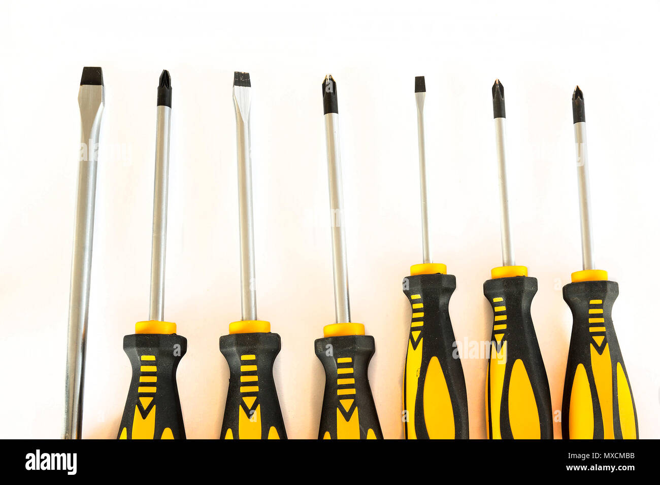 Set of screwdrivers with rubber black and yellow handles isolated on a ...