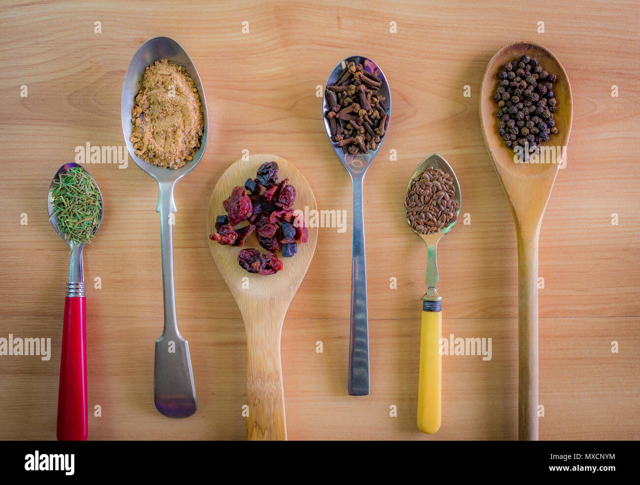 Various spoons with spices and dried fruit Stock Photo - Alamy