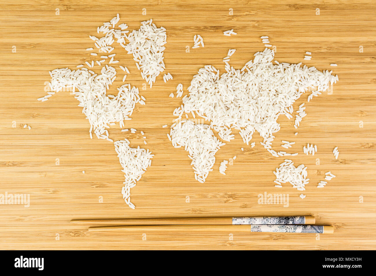 map of the world made of white rice on bamboo wood background with two ...