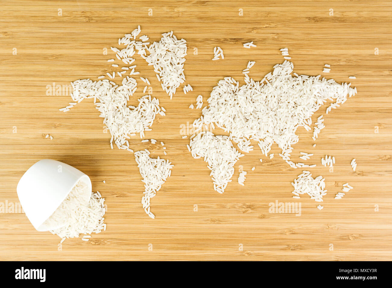 map of the world made of white rice on bamboo wood background with ...