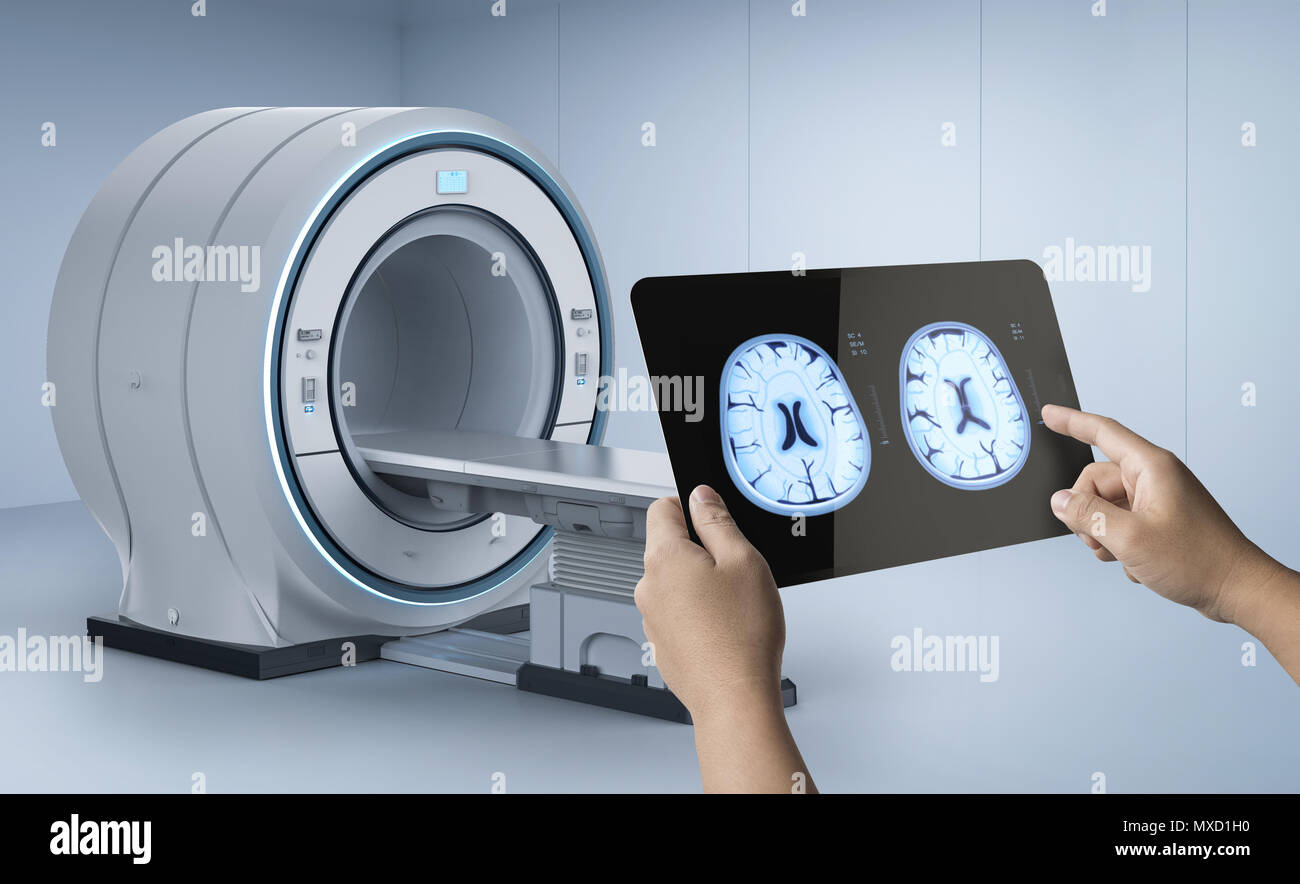 Hand holding 3d rendering tablet display x-ray brain with mri scan machine Stock Photo - Alamy
