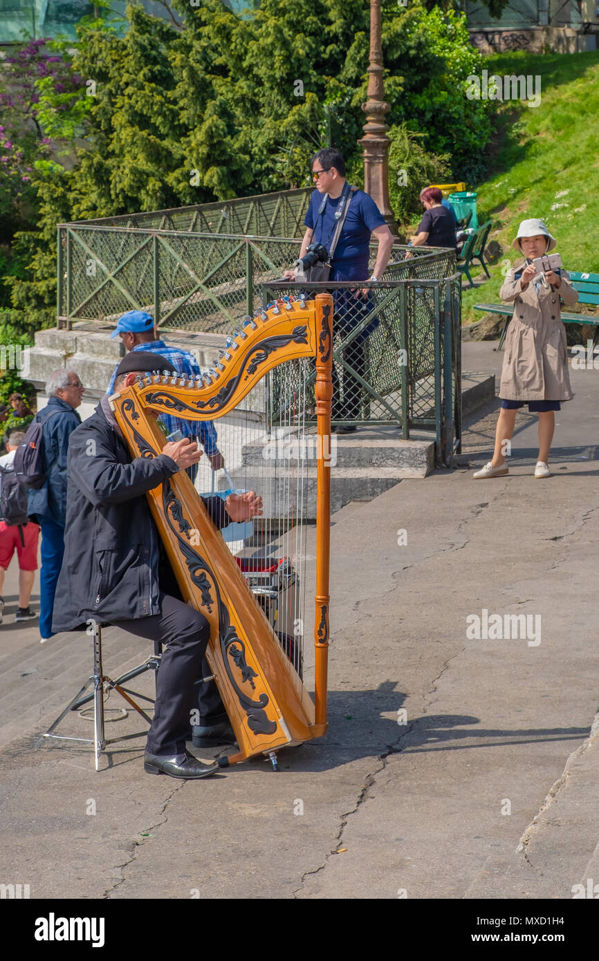 Man playing his harp on the steps to Sacre-Coeur Basilica in Parais ...