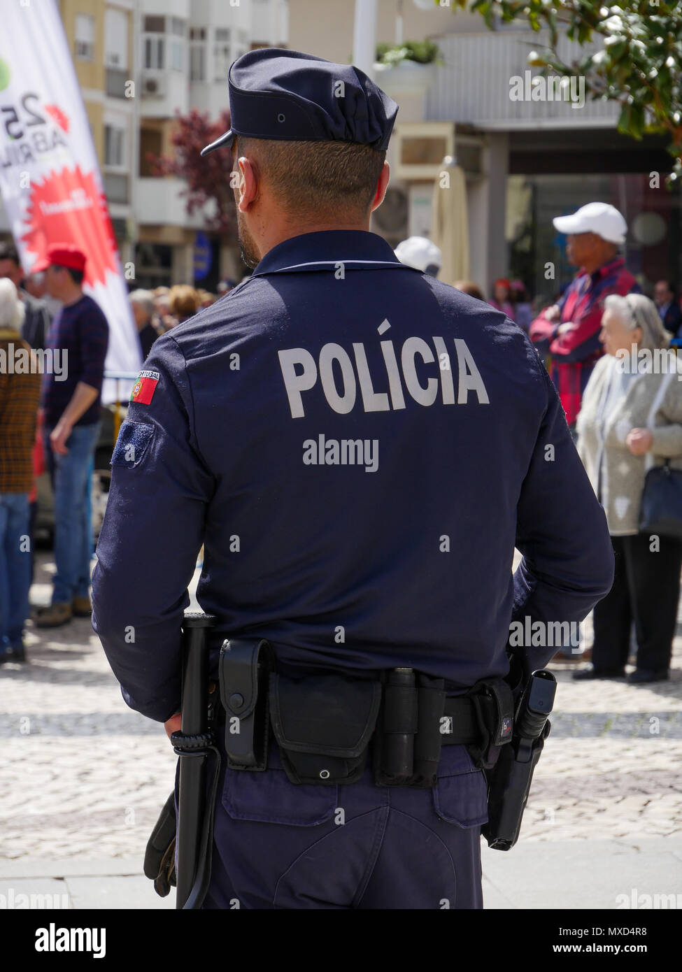 A police officer overloks demontrators gathered on the occasion of ...