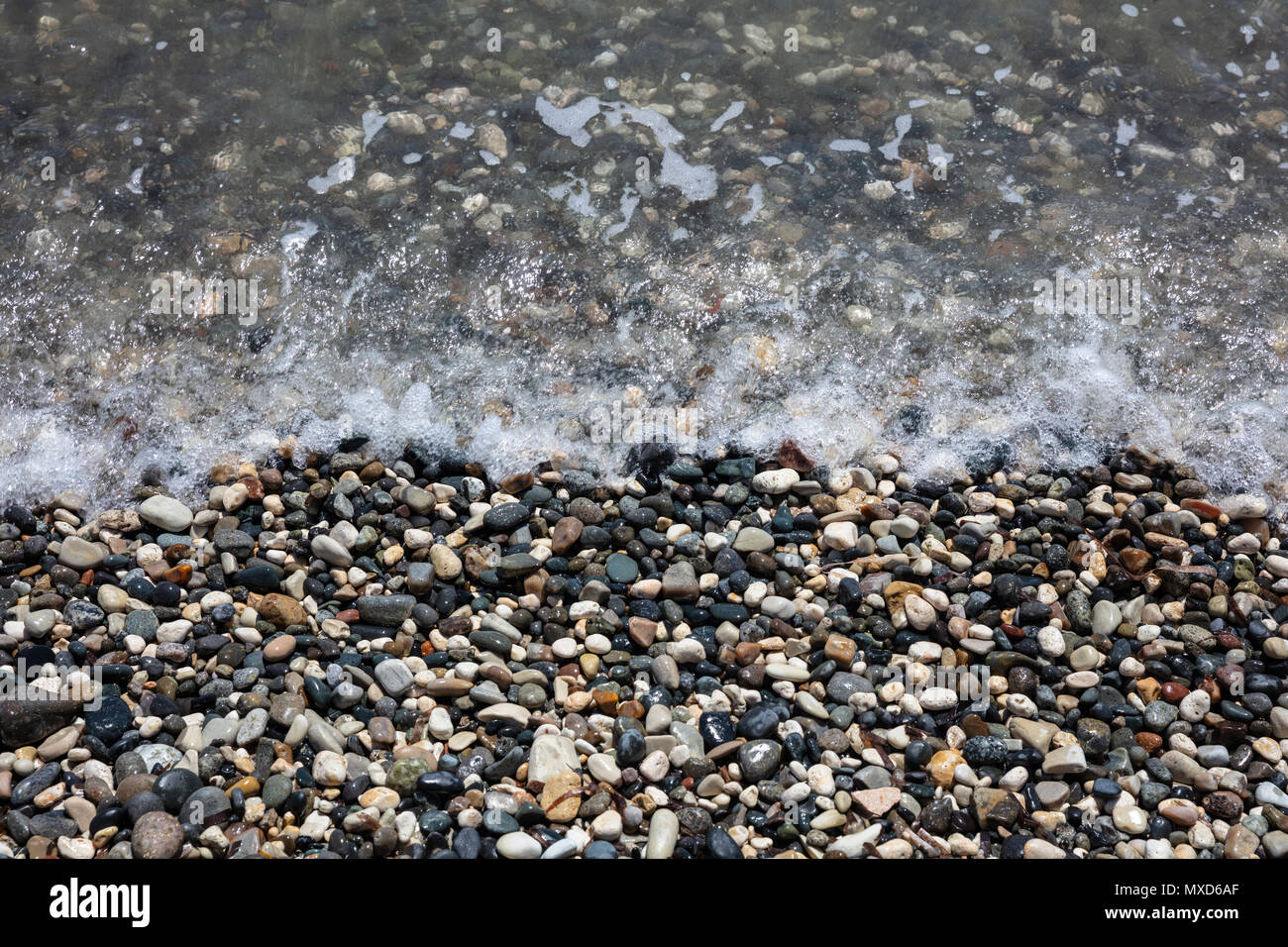 Pebbles beach. Natural wet pebbles and sea water background Stock Photo ...