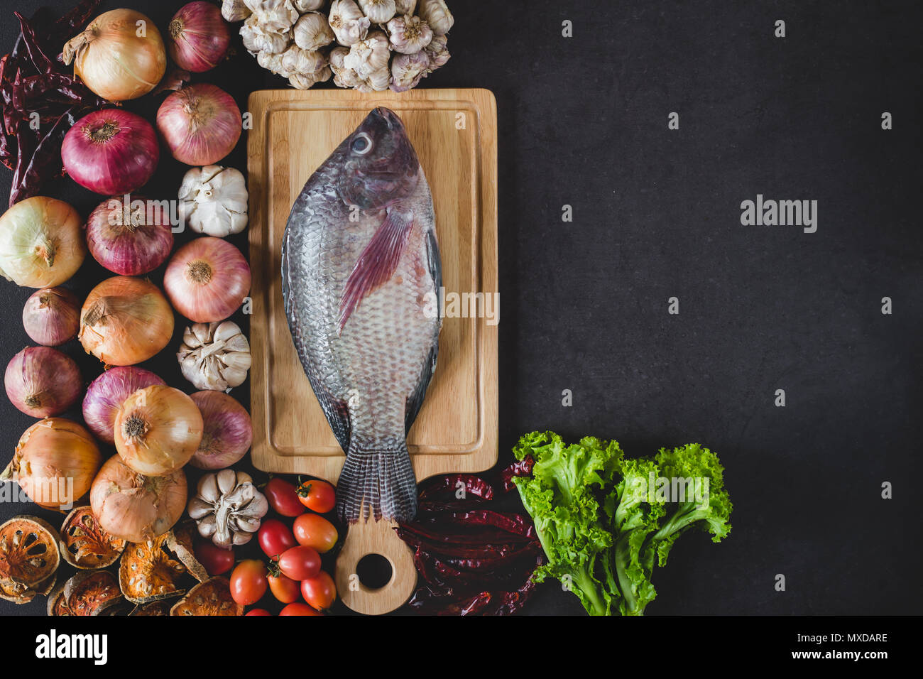 Raw fish cooking and ingredients. herbs and spices. Top view on stone ...