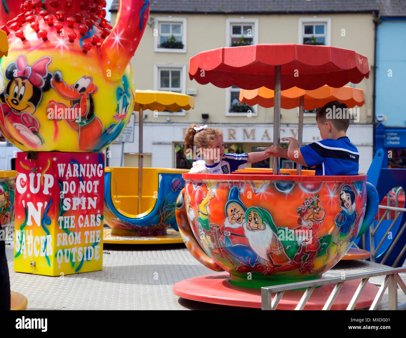 Boy and girl in Cup n saucer ride, Carrickmacross funfair Stock Photo ...